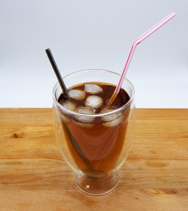 Iced Tea with Red and Blue Straw on Wooden Table, White Background ...