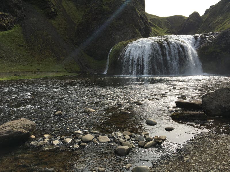 A Pebbled Stream Created by a Waterfall in the Background. Stock Image ...