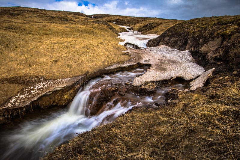 Icelandic Wilderness - May 08, 2018: Small Waterfall in the Icy ...