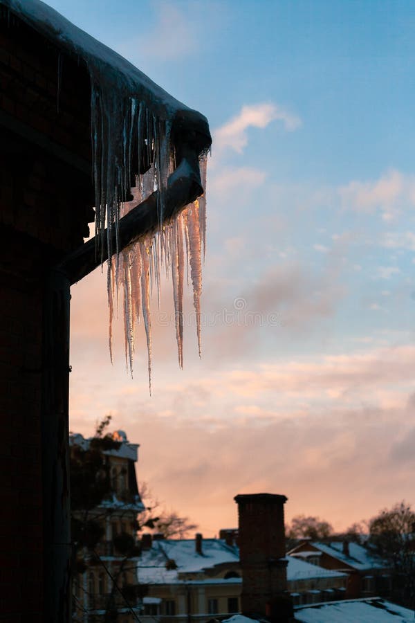 Icicle on the Edge of the Roof with Sky Background Sunset Light Stock ...