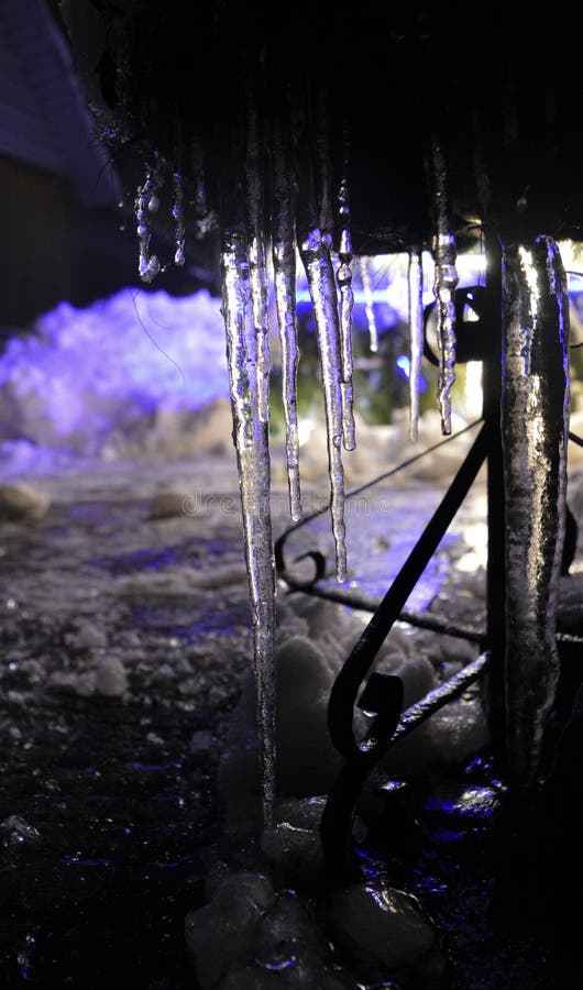 Icicles Against the Background of Purple Lights. Stock Image - Image of ...