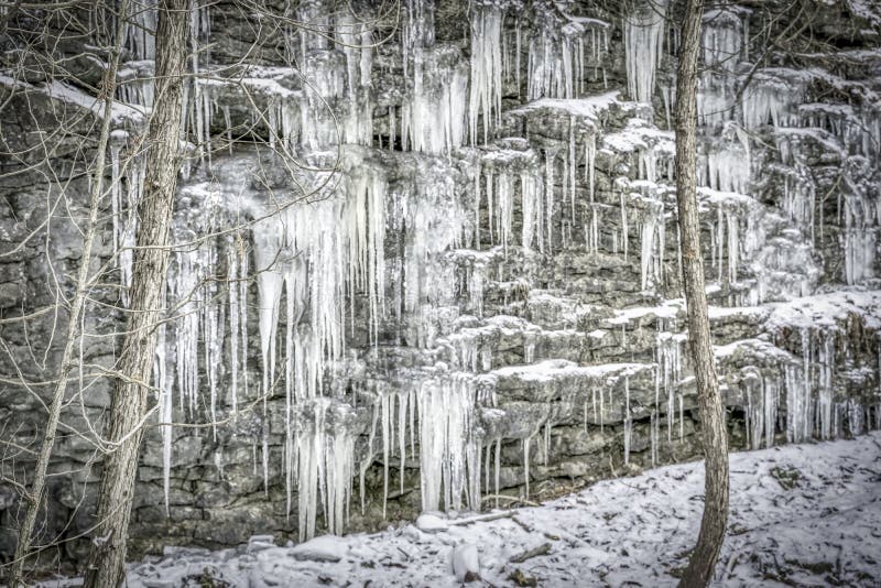 Icicles on a Rock Cliff Face in Late Fall Stock Photo - Image of ...