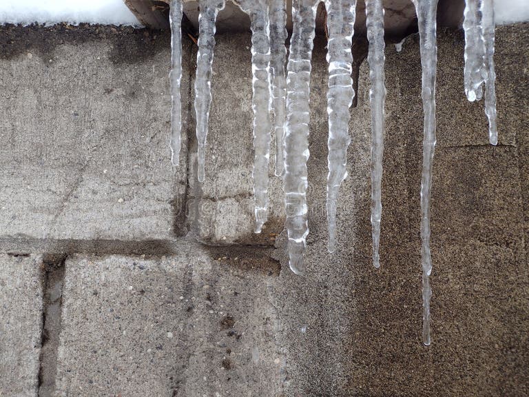 Icicles on a Cement Block Wall Stock Image - Image of light, tree ...