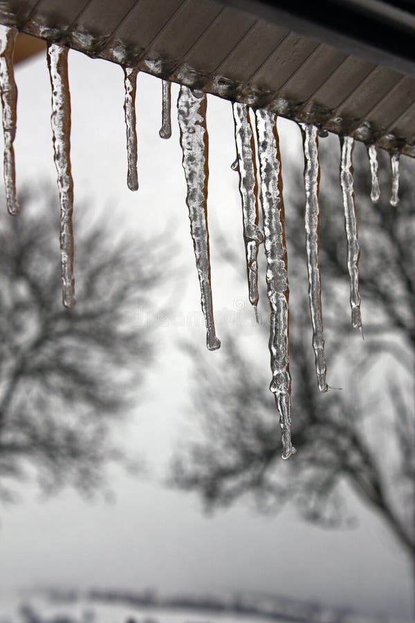Icicles in Full Sunlight on the Edge of a Roof. Stock Image - Image of ...