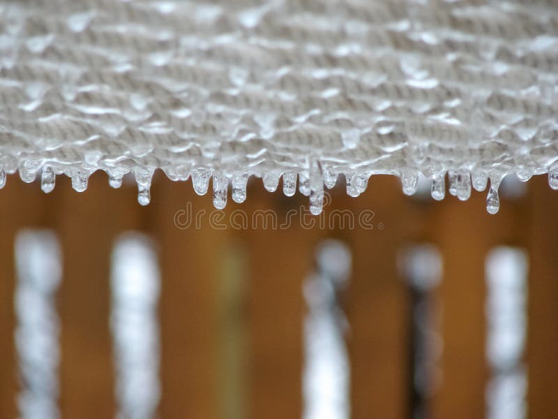 Icicles Hang Frozen from the Bottom of Rope with Selective Focus Stock ...