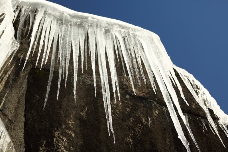 Icicles Hang on the Rock with Blue Sky. Stock Image - Image of ...