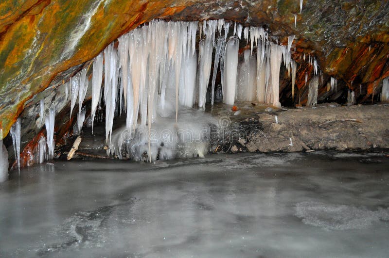 Icicles hanging from rocks stock photo. Image of cold - 12452158