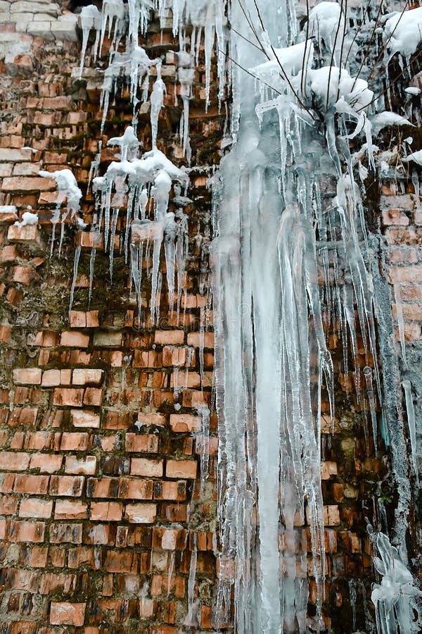 Icicles, Ice Build-up on the Background of a Brick Wall, Closeup ...