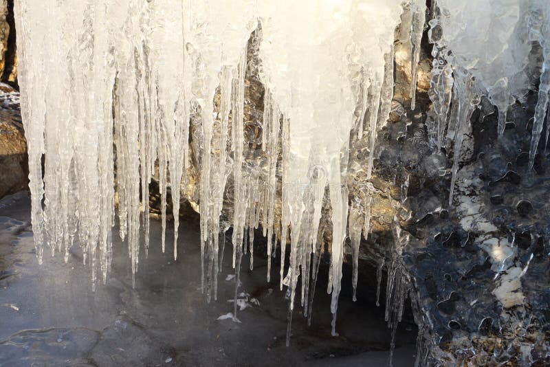 Icicles on a Stone on the Bank of the River Stock Photo - Image of ...