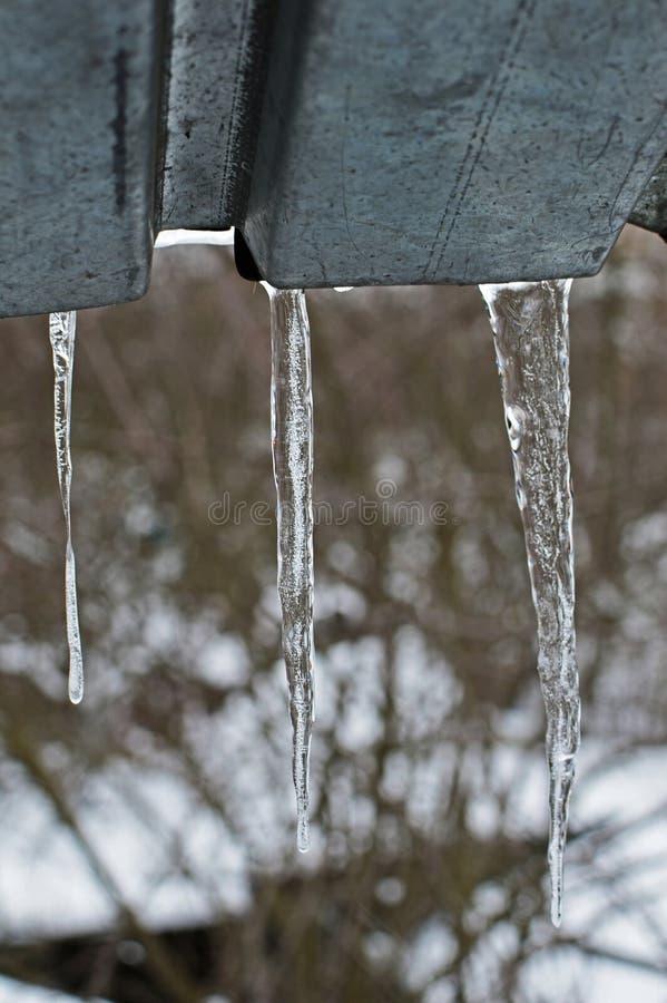 Icicles of Various Shapes Hang from the Metal Roof Stock Image - Image ...