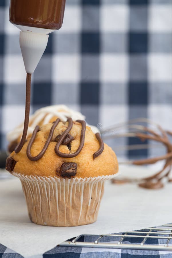 Icing Frosting Being Put Onto Home Made Chocolate Chip Muffins Stock ...