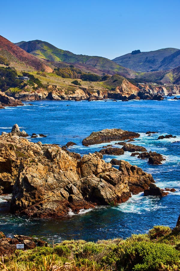 Iconic Highway One Bridge in Distance with Waves and Rocky Cliffs Stock ...