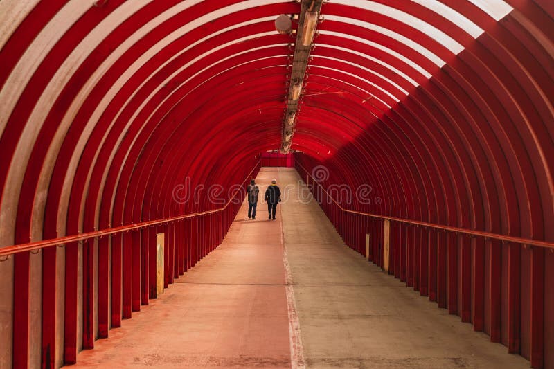 Iconic Red Walkway with Arched Metal Beams in Glasgow, Visible Two ...