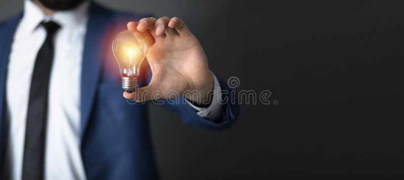 Man holding light bulb stock photo. Image of success - 224929372