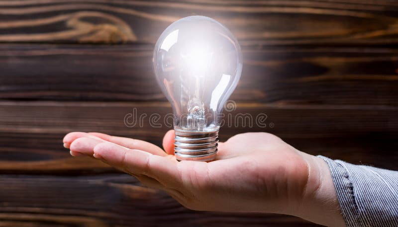 Idea. Hand and Bright Light Bulb Stock Illustration - Illustration of ...