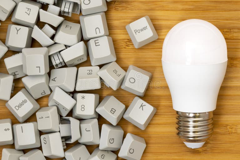 LED Light Bulb and Pile of Computer Keyboard Keys Stock Image - Image ...