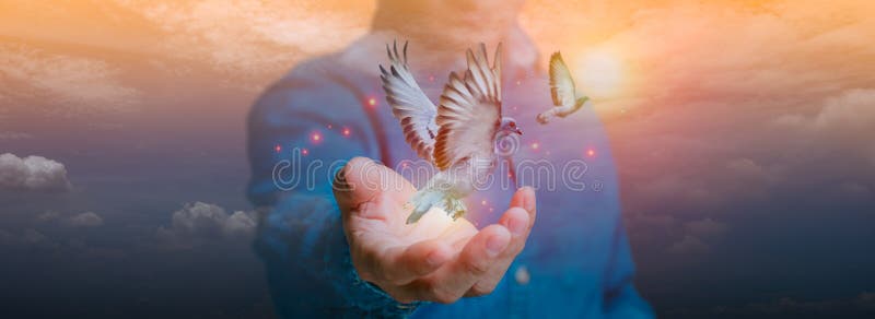 The Idea of a Man Praying and Releasing the Birds Soaring Against a ...