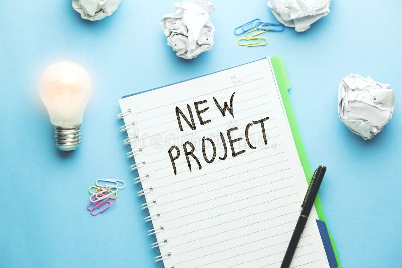 Idea with New Project Text on Page Stock Photo - Image of bulb, table ...