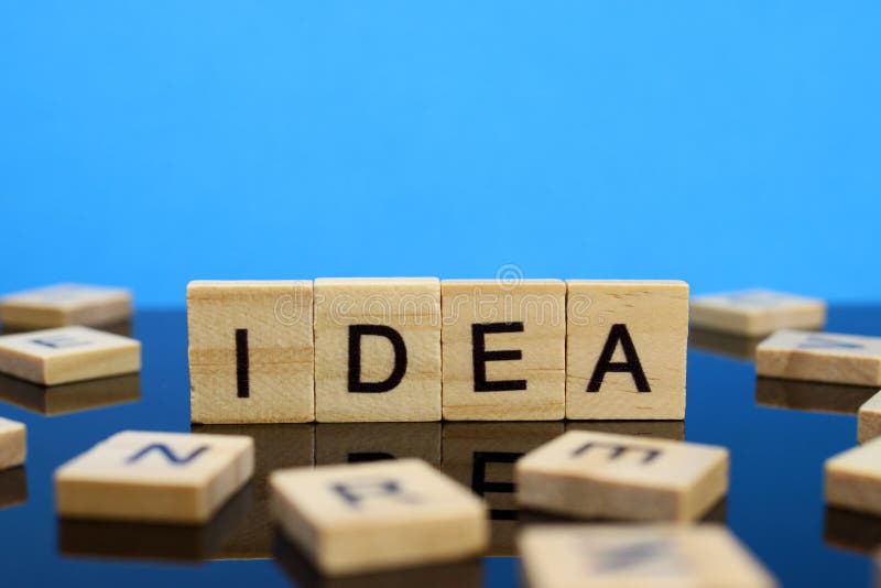 Idea Word Made of Wooden Letters on a Mirror Surface on a Blue ...
