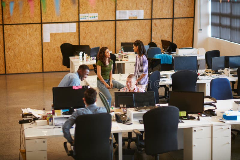 Ideas in Progress. a Team of Colleagues Having an Informal Meeting in a ...