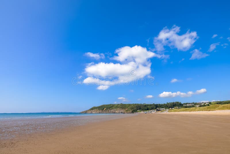 An Idyllic Beach Setting with Deep Blue Seas and Bright Blue Sky Stock ...