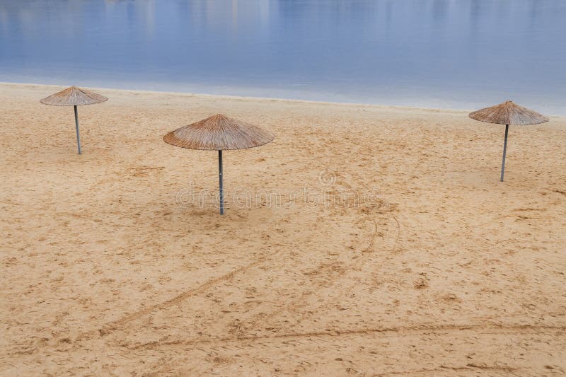 Idyllic Empty Sand Beach with Three Umbrella Near Shore Line with ...