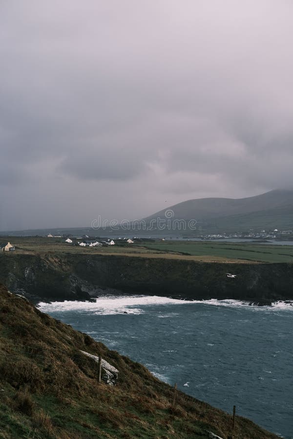 Idyllic Landscape Featuring a Farm Situated on a Grassy Hill ...