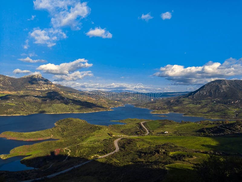 Idyllic Landscape of a Lake Amidst Mountain Range Against Cloudscape ...