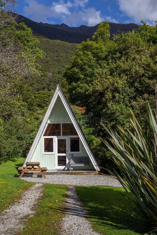 Idyllic Mountain Retreat with a Triangular-shaped Cabin Surrounded by ...