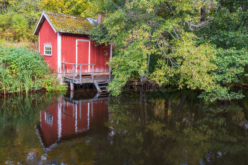Idyllic Red Bath House by the Water with a Jetty Stock Photo - Image of ...