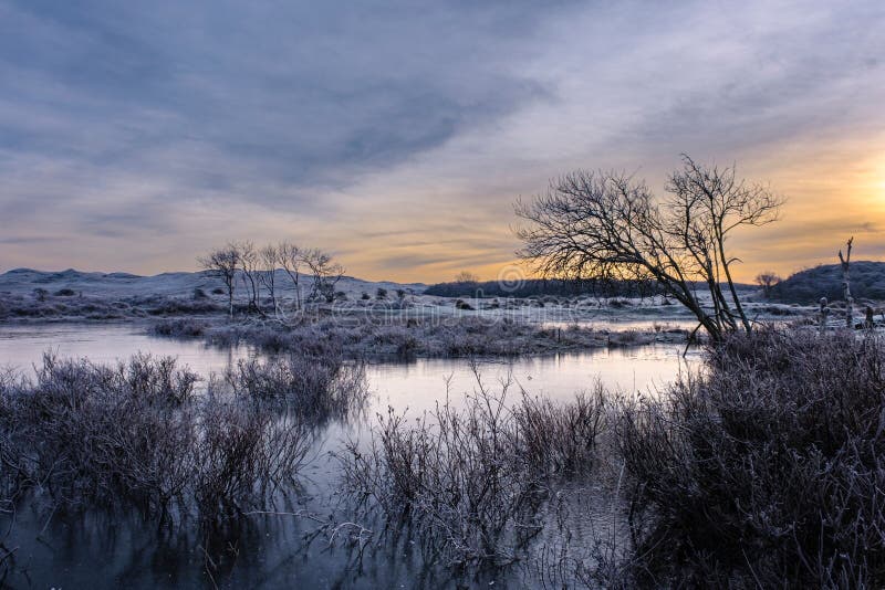 Idyllic Winter Scene with a River Partially Frozen Over and Illuminated ...