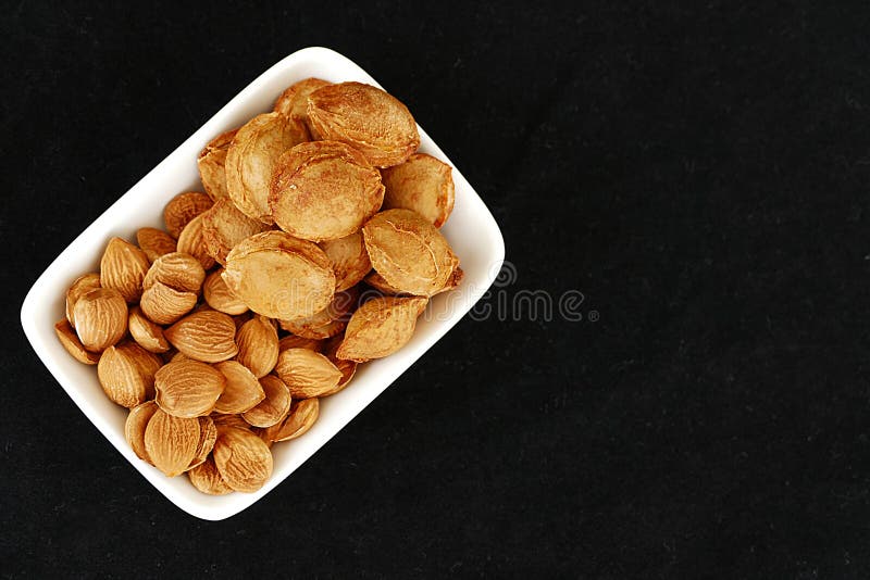 Eat Apricot Kernels in Plates, on Black Ground, Sweet Apricot Seeds ...