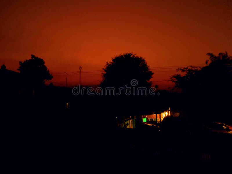 Ignited Light in Farmhouse Rooftop in the Dark at Orange Sky Sunset ...