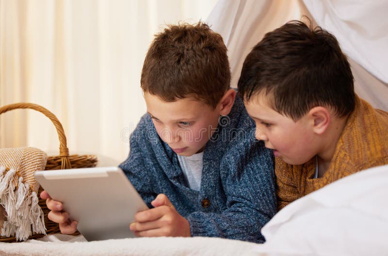 Igniting Their Curious Minds. Two Brothers Using a Digital Tablet ...