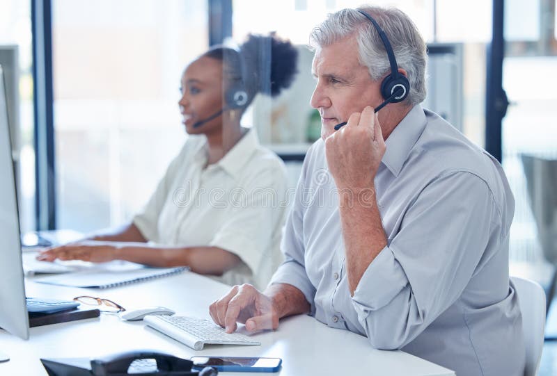 Ill Log that into the System. a Mature Call Centre Agent Working on a ...