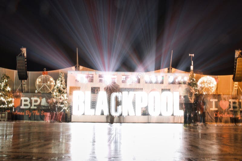 Illuminated Blackpool Sign with Light Rays at Night, Reflecting on Wet ...