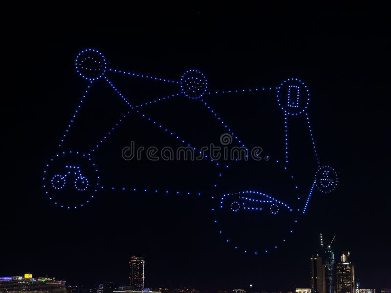 Illuminated Blue Drones Glowing in the Black Night Sky and Forming ...