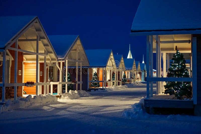 Illuminated Cabins with Christmas Trees in the Arctic Snow Stock Photo ...