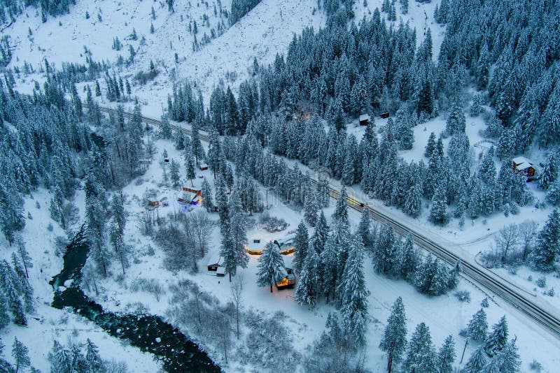 Illuminated Cabins and the Snow Covered Cascade Mountains in Washington ...