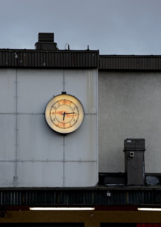 Illuminated Clock on the Wall Stock Image - Image of evening, gray ...