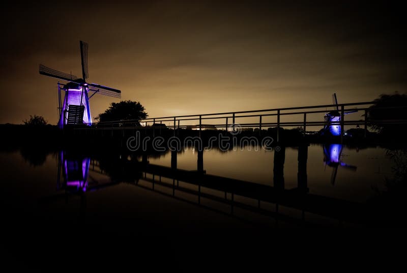 Illuminated Dutch Windmills Near the River at Night Stock Photo - Image ...