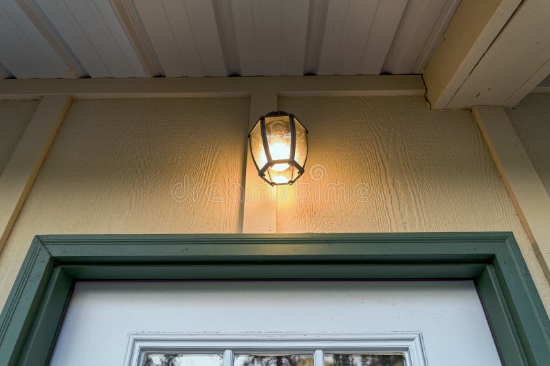An Illuminated Electric Light Fixture Above an Exterior Door Stock ...