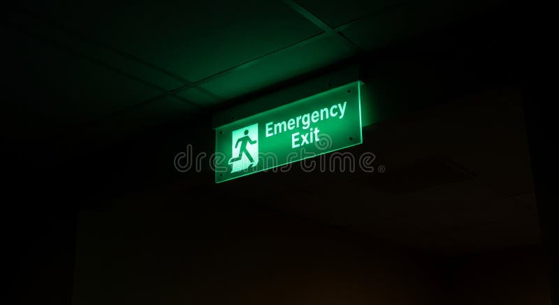 Illuminated Emergency Exit Sign a Glowing Green Emergency Exit Sign ...