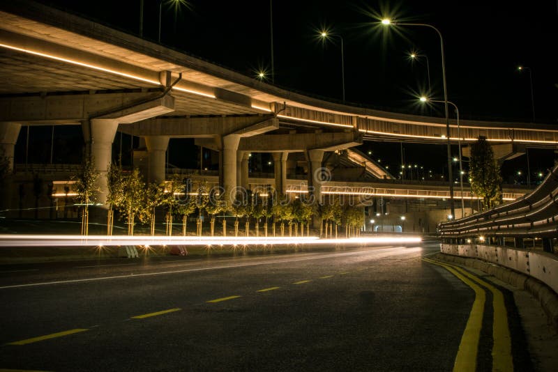 Illuminated Empty Road and Giant Bridge at Night Stock Image - Image of ...