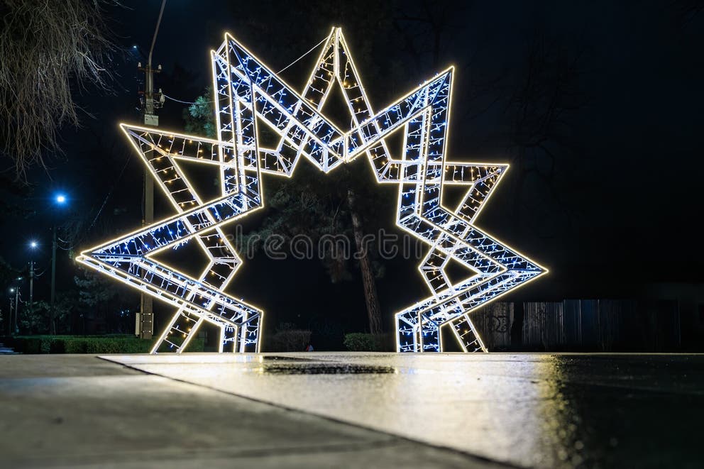 Illuminated Geometric Star Structure at Night in a Park Stock Image ...