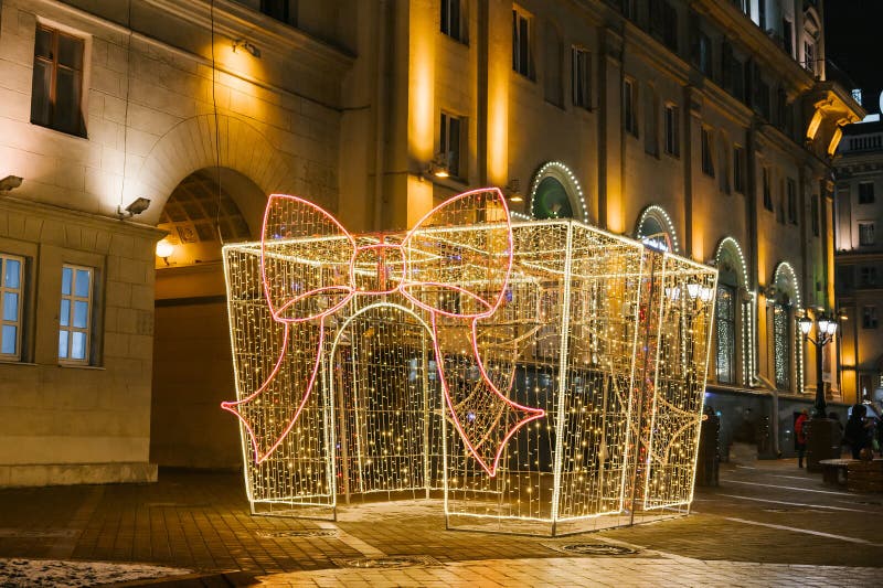 Illuminated Gift Box with Bow in City Square at Night Stock Image ...