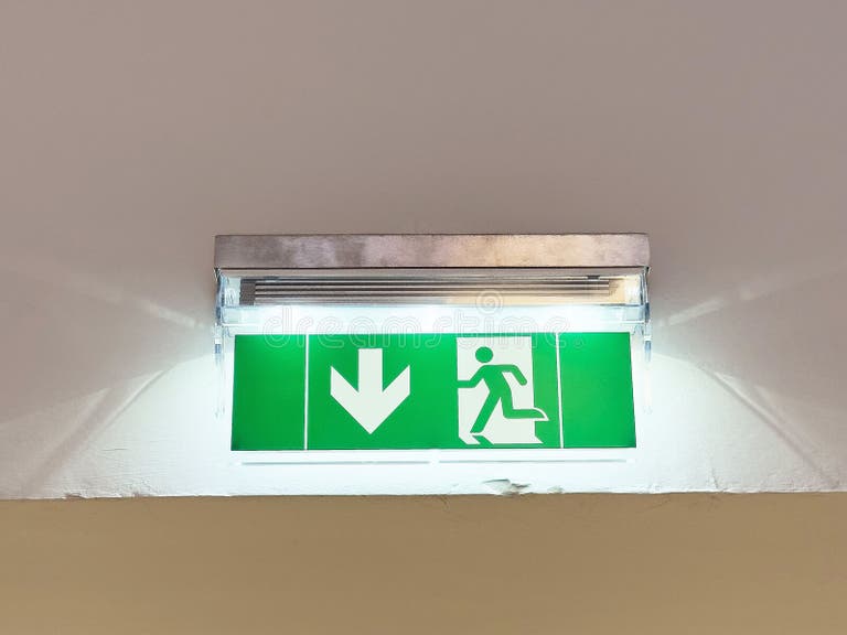 Illuminated Green Emergency Exit Sign with Arrow and Running Figure ...