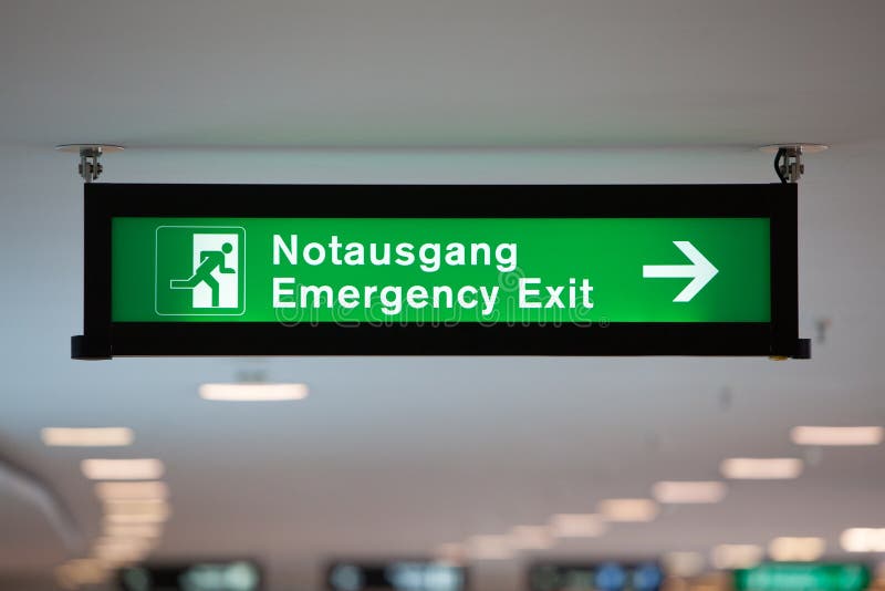 Illuminated Green Emergency Exit Sign Stock Photo - Image of hanging ...