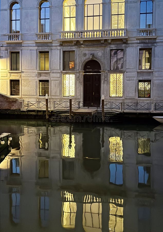Illuminated Historic Building and Its Reflection on Calm Water at Night ...