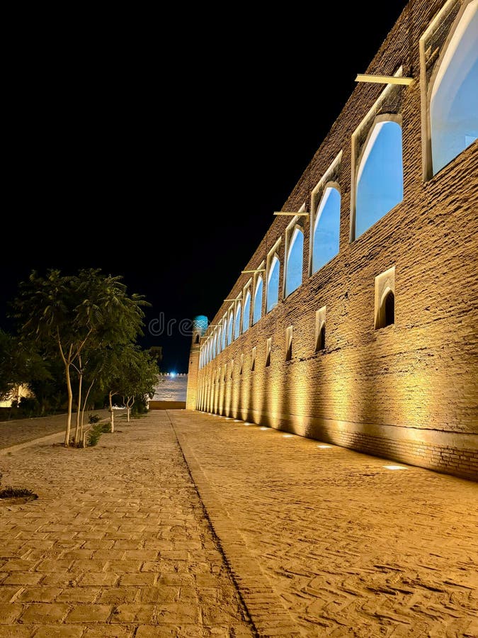Illuminated Historic Wall with Arched Windows and Night Path Stock ...